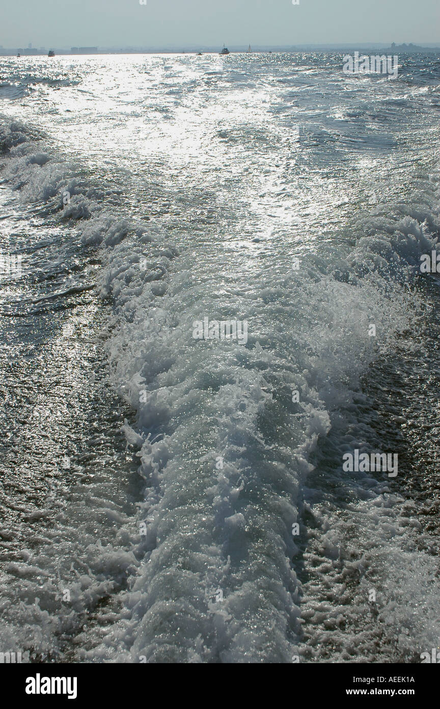 Small power boat wake Stock Photo - Alamy