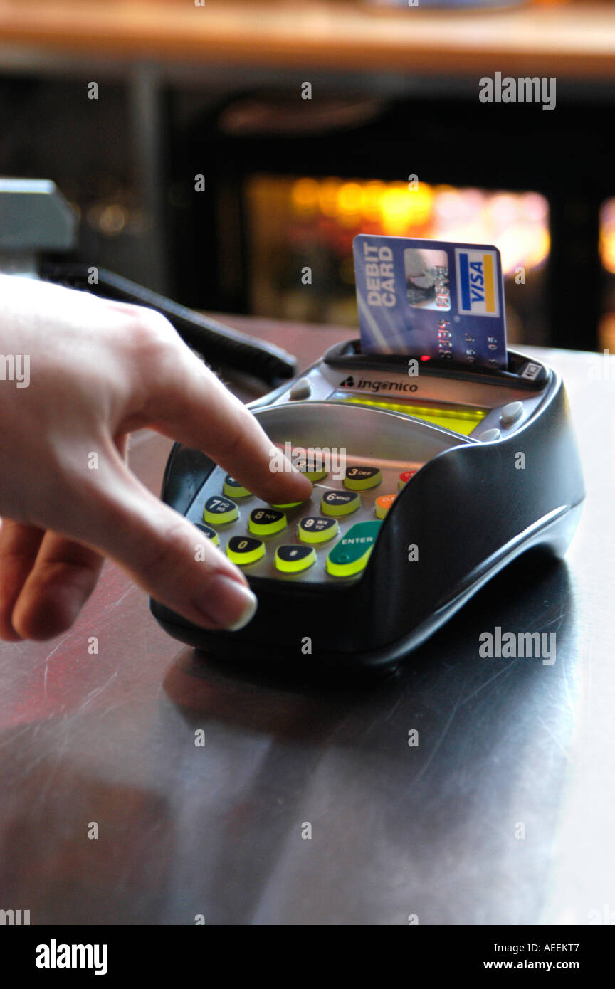 Paying with chip and pin machine at a bar, England, UK Stock Photo - Alamy