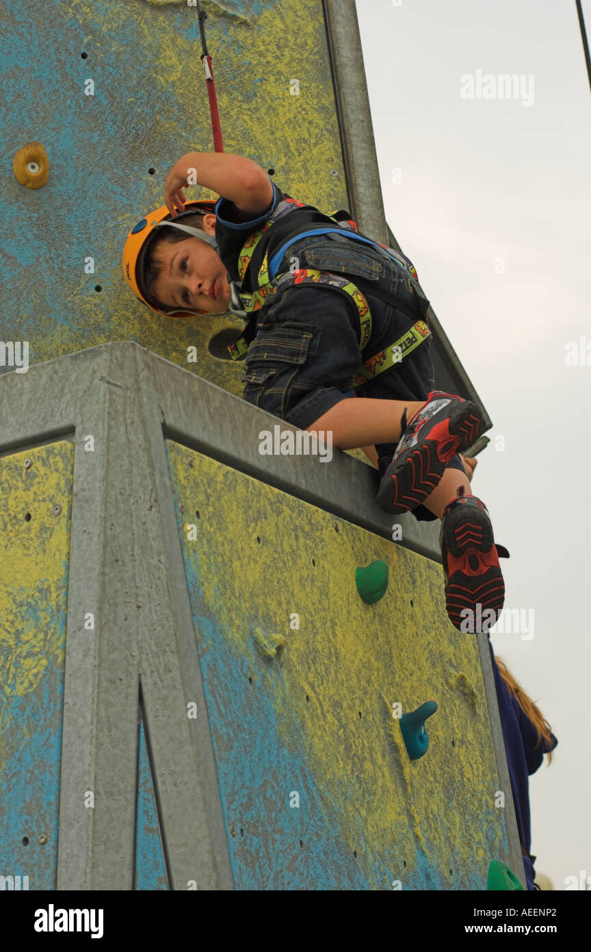 Young boy on climbing wall reaching ledge Stock Photo - Alamy