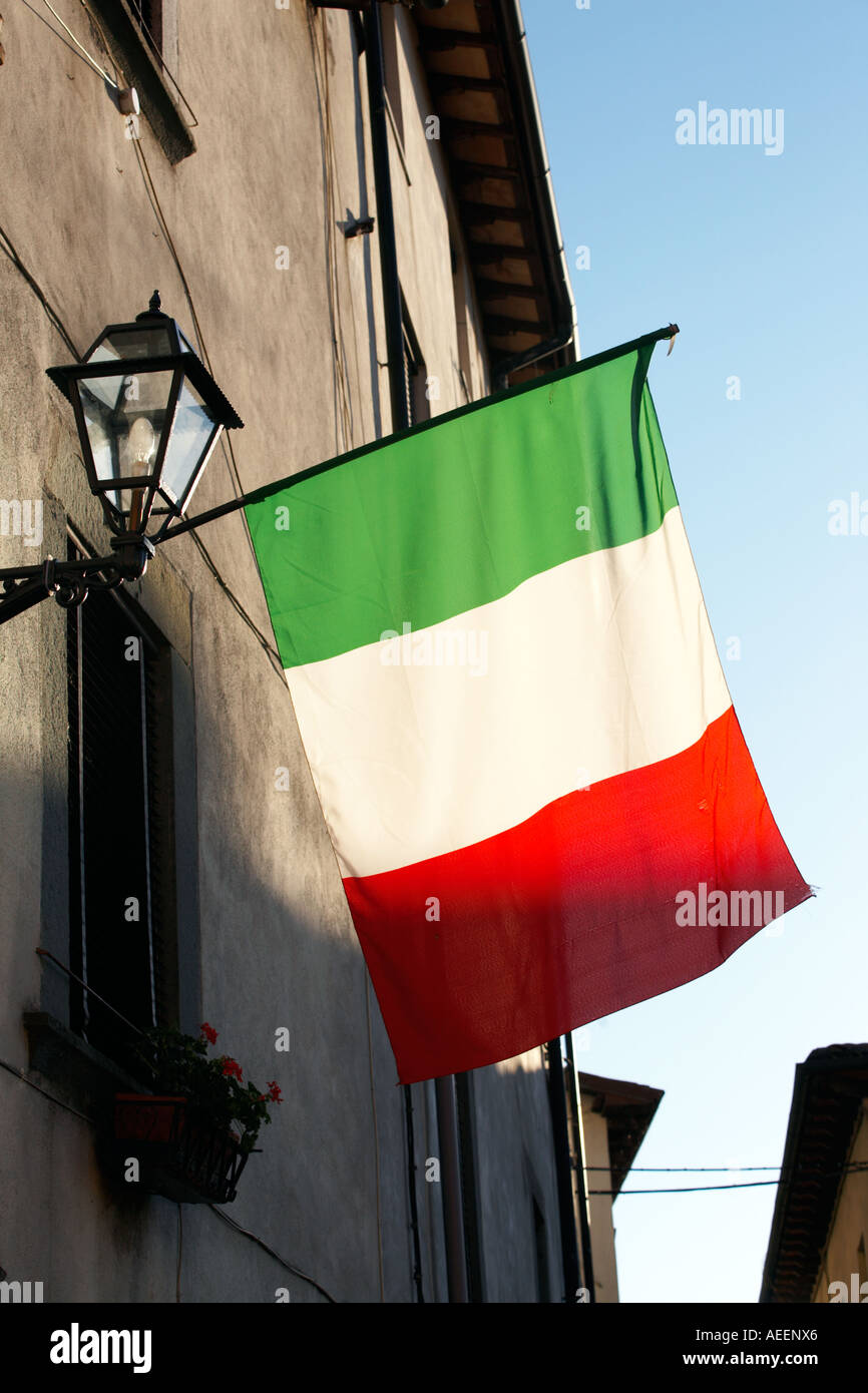 The Italian flag hanging from a pole in a street in the Italian town of ...