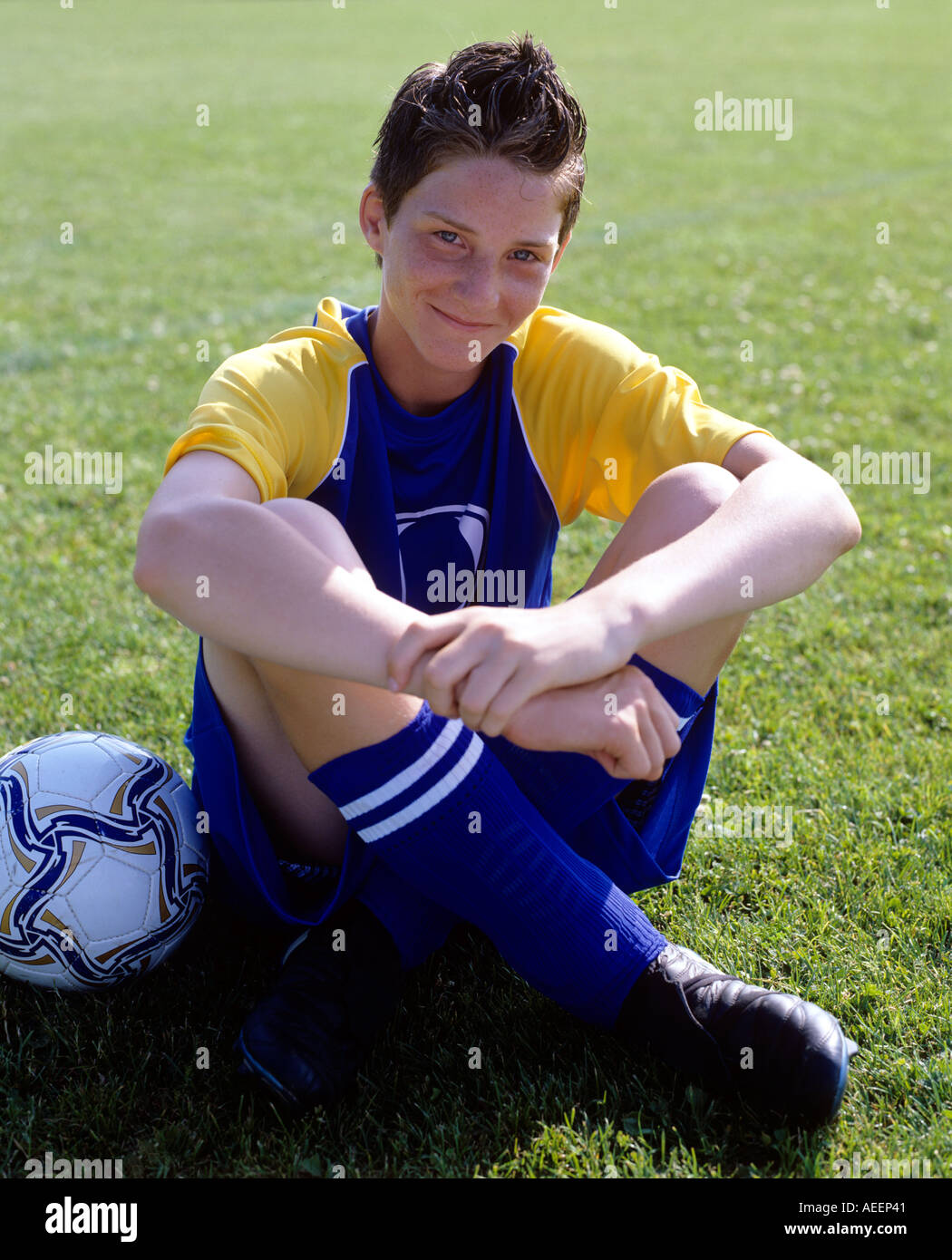 portrait of smiling male teenage football player with football Stock ...