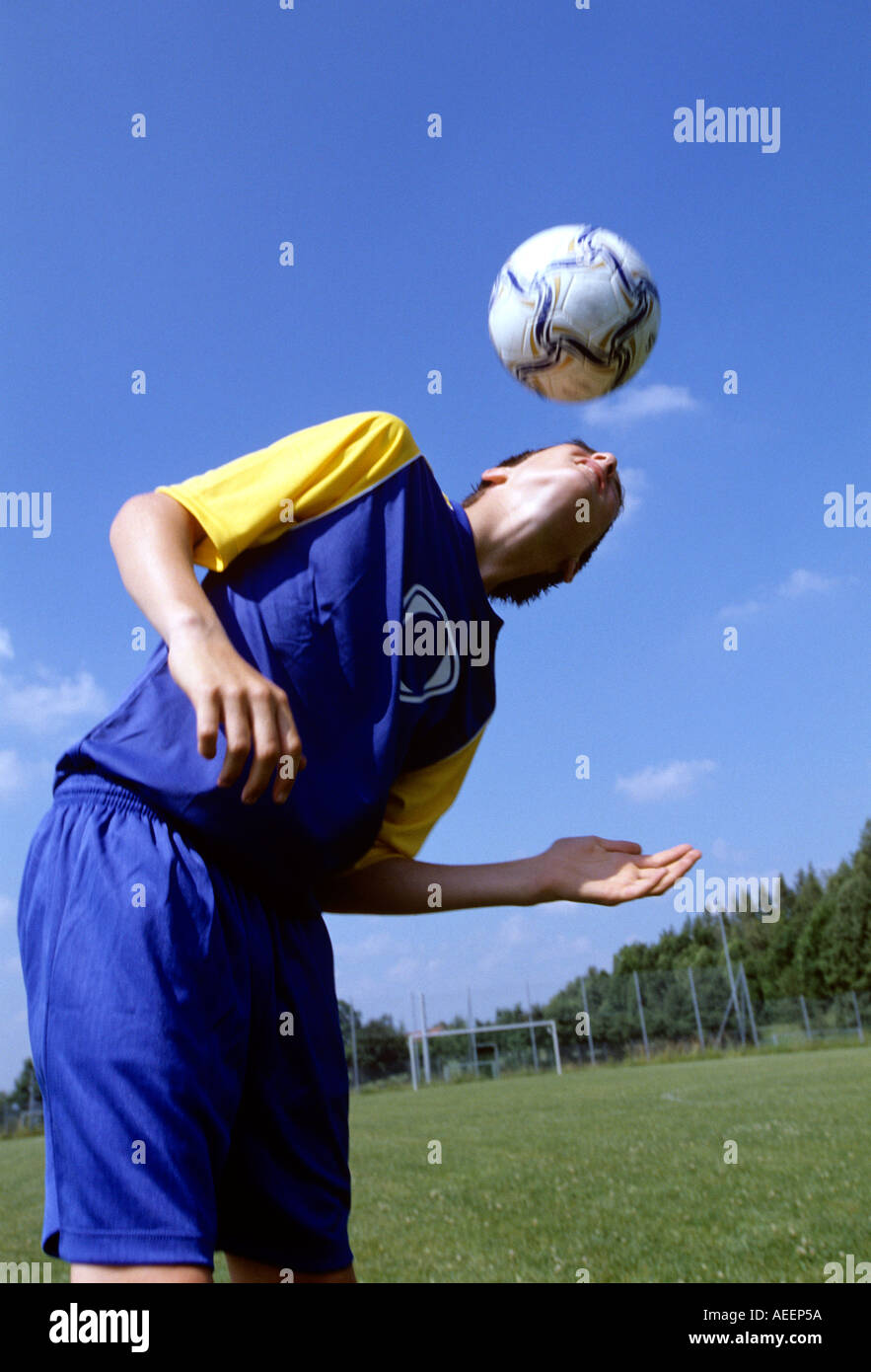 teenage footballer playing keepy uppy with the ball Stock Photo - Alamy