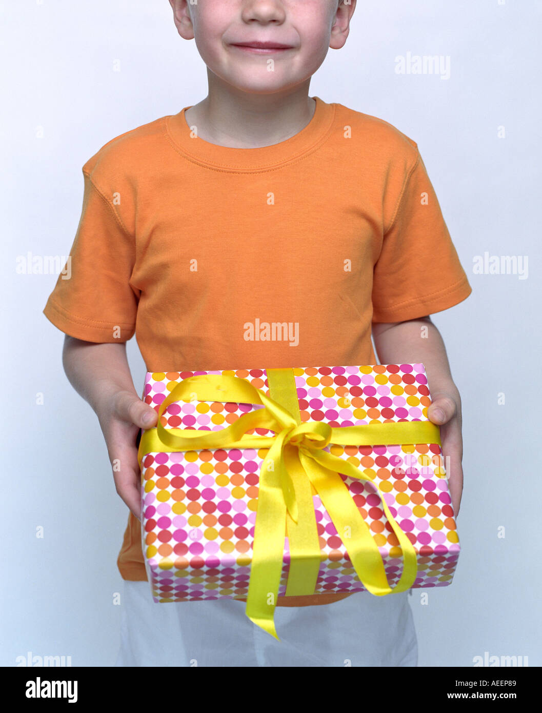 little boy with colorfully wrapped birthday present in his hands Stock ...