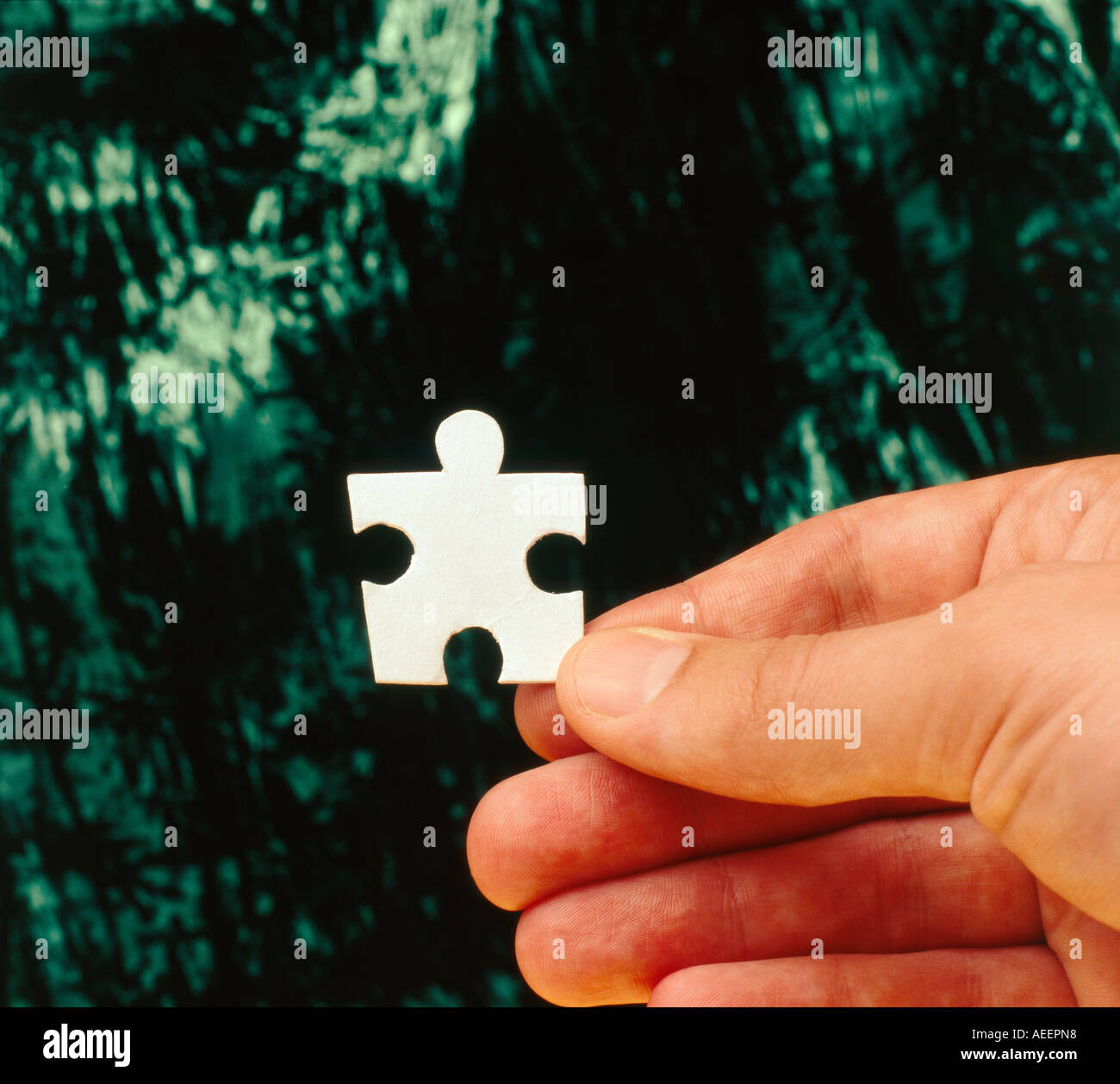 Human hand holding a jigsaw piece hi-res stock photography and images ...