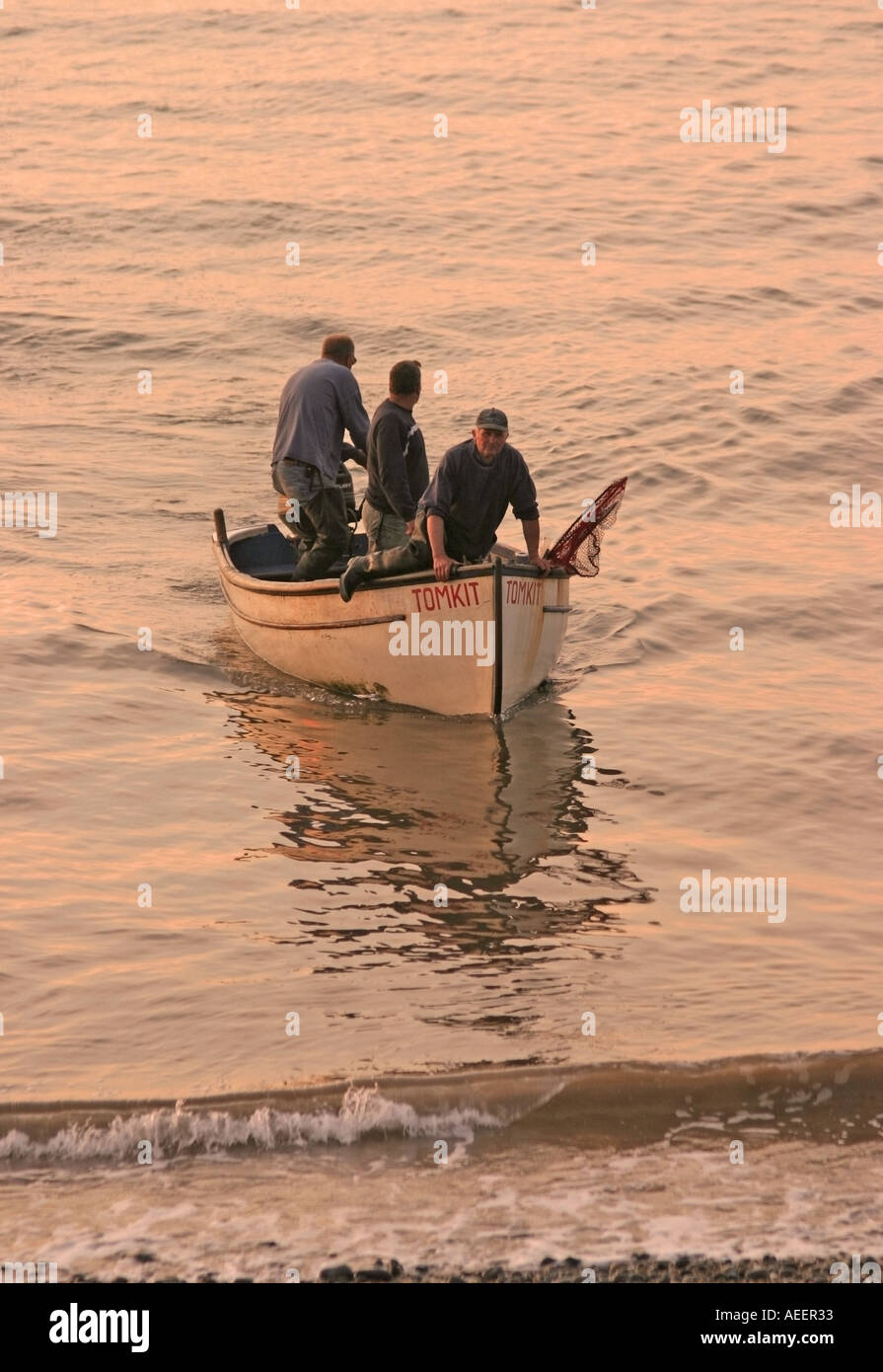 Three Sea Fishermen in a Boat Stock Photo - Alamy