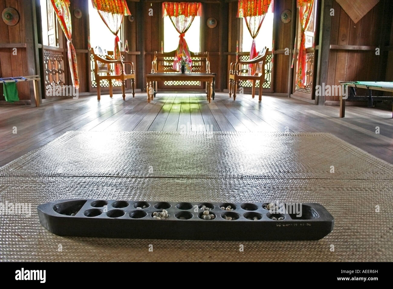 Interior of a traditional Malay house. On the foreground is an ...