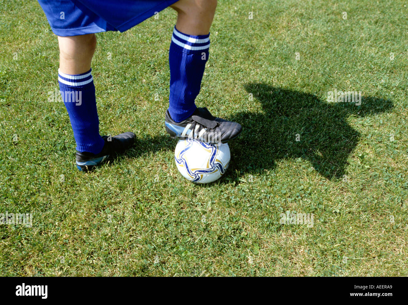 detail of football player standing on ball Stock Photo - Alamy