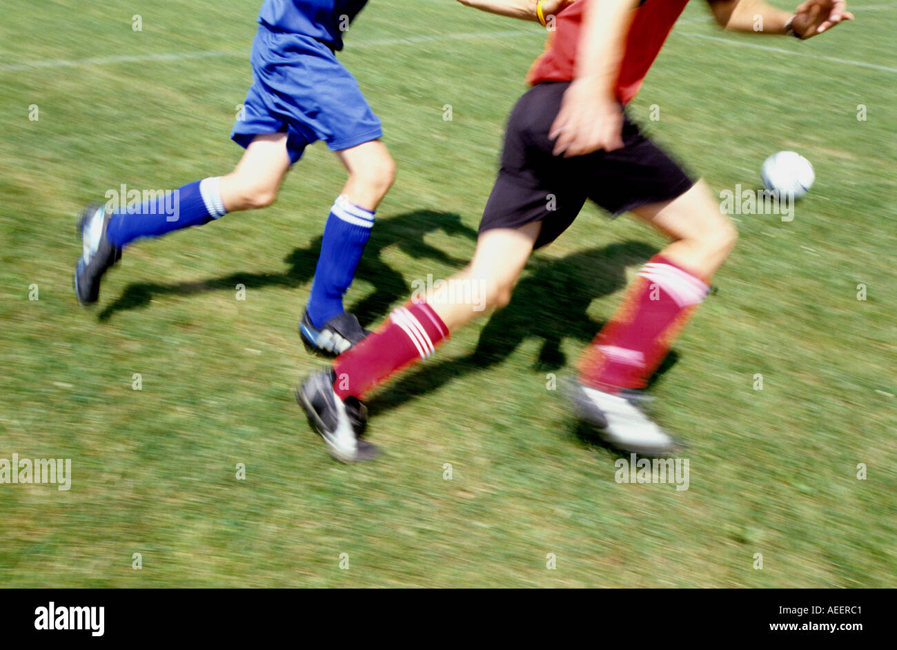 two football players running after the ball Stock Photo - Alamy