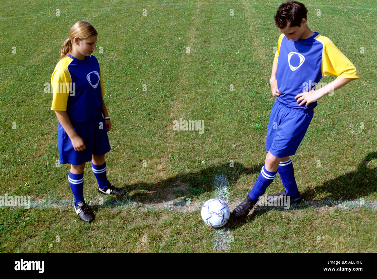 teenage boy passing football to girl Stock Photo - Alamy