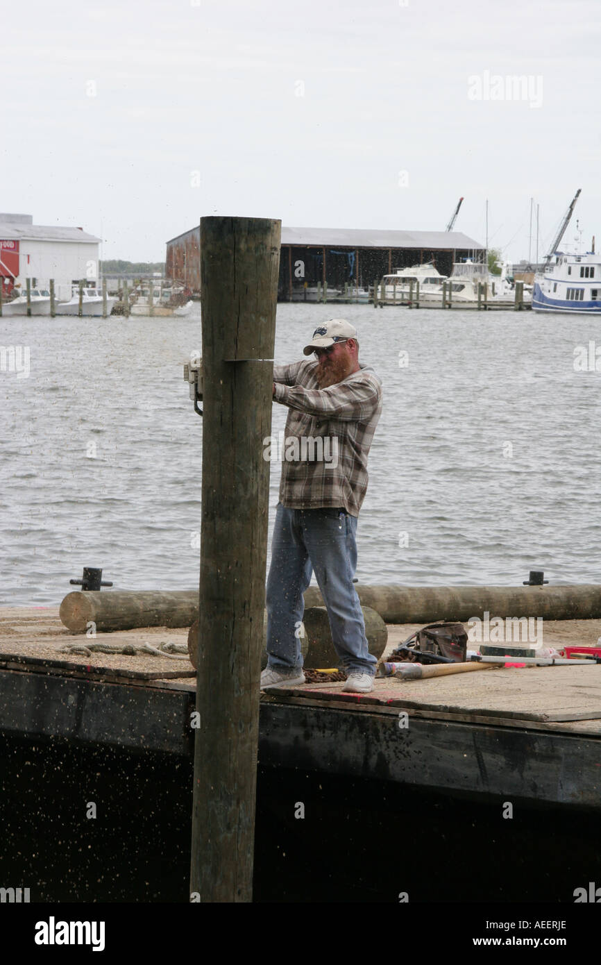Marine construction worker cuts top off piling hi-res stock photography ...