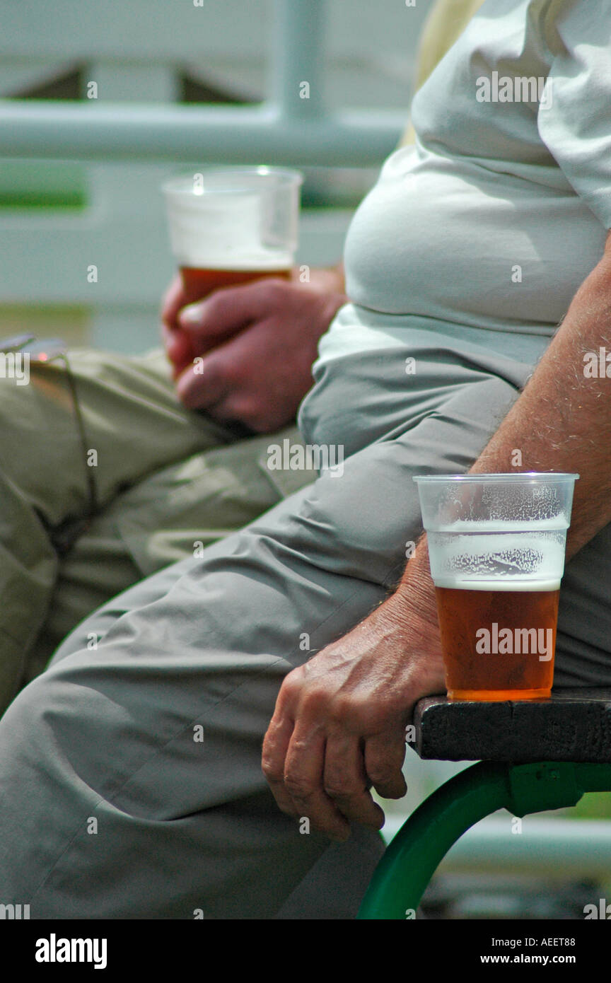 Two middle aged men drinking beer outside Stock Photo - Alamy