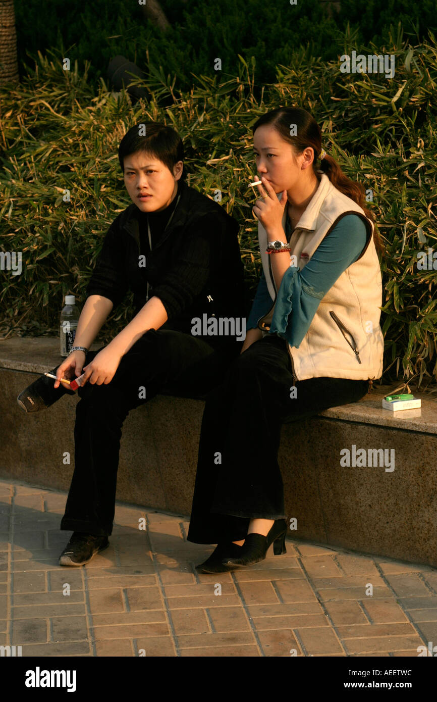 Shanghai China Women shop workers taking a smoking break in Pu Dong ...