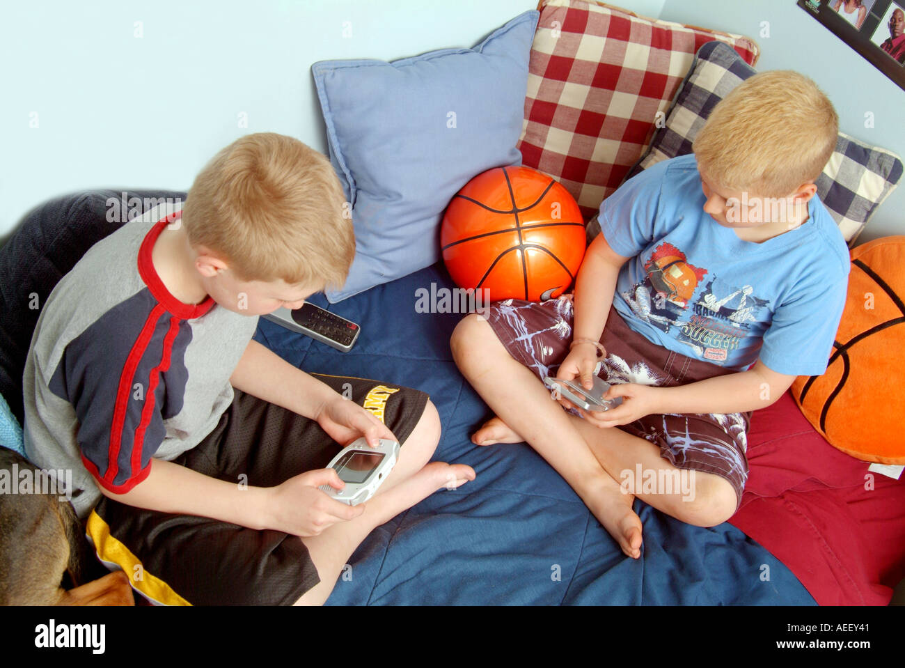 2 Young boys playing video games in his bedroom Stock Photo - Alamy