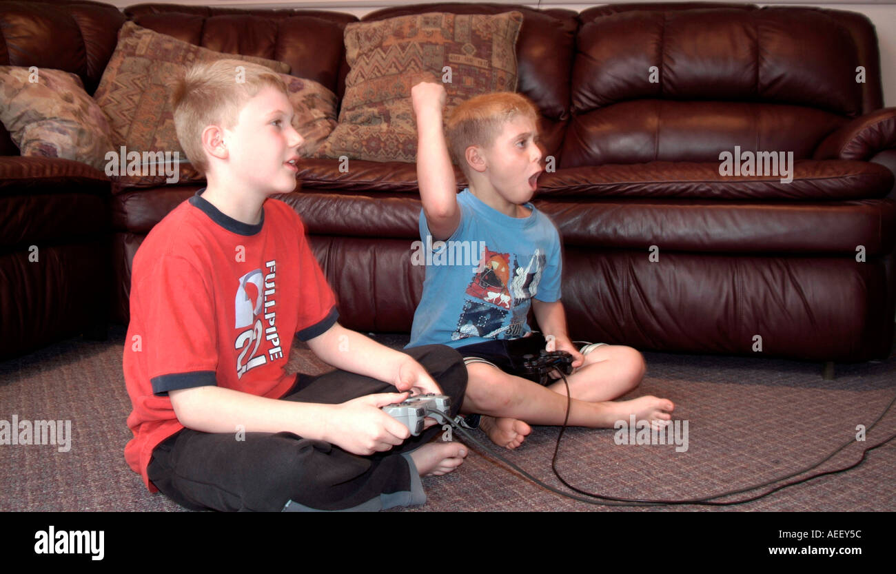 2 young boys playing video games in living room Stock Photo - Alamy