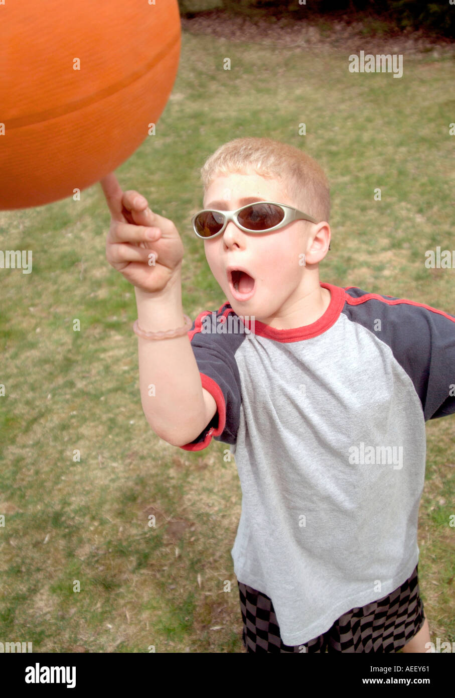 Young boy spinning basketball on his finger Stock Photo - Alamy
