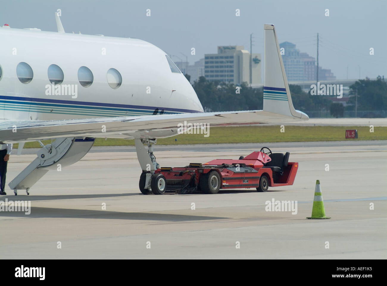 aircraft tow tractor with jet towcar on tarmac Stock Photo - Alamy