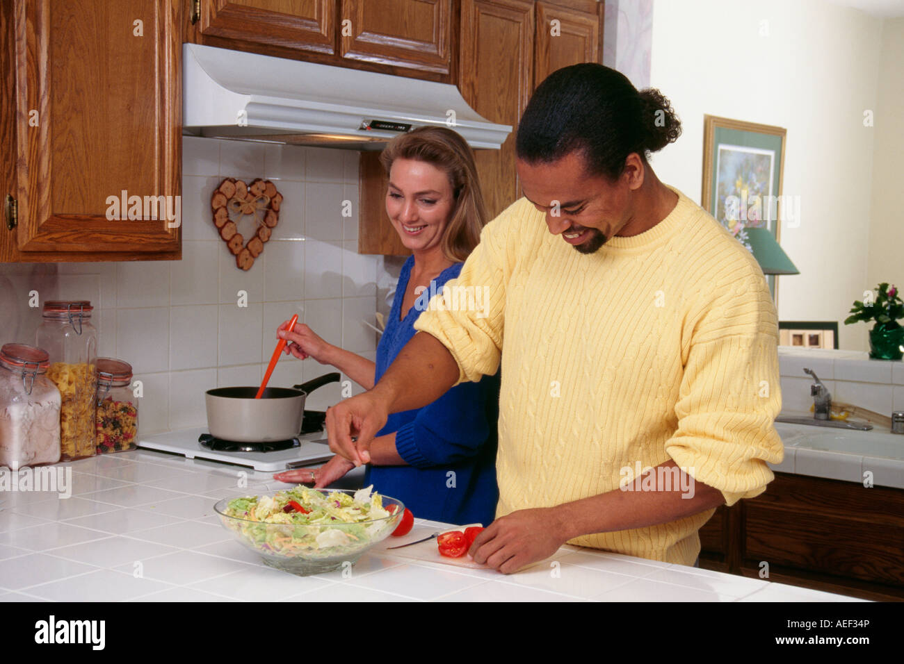 Man and woman cook dinner and enjoy each other friendship friends ...