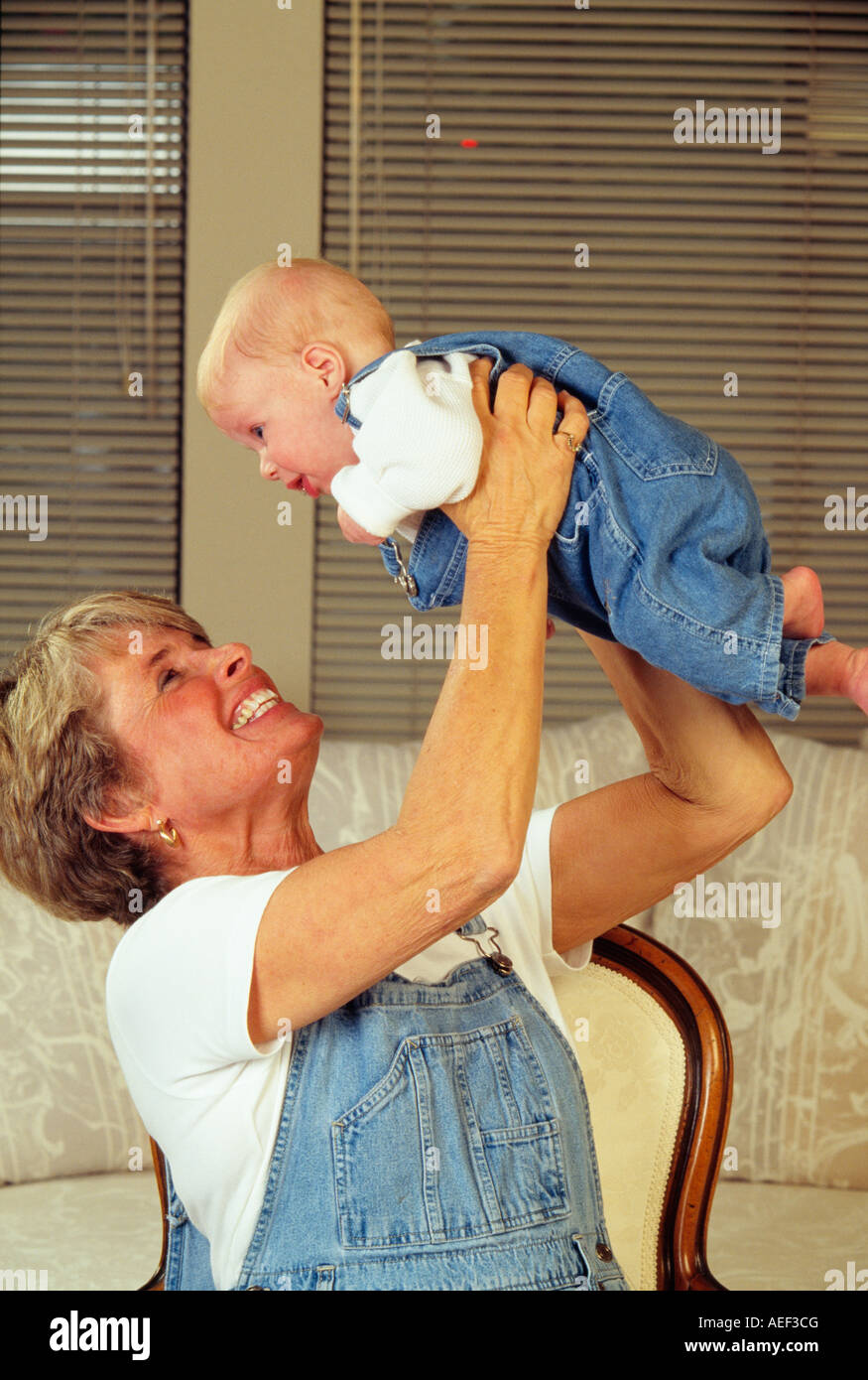 Mother lifting baby boy in arms Stock Photo - Alamy
