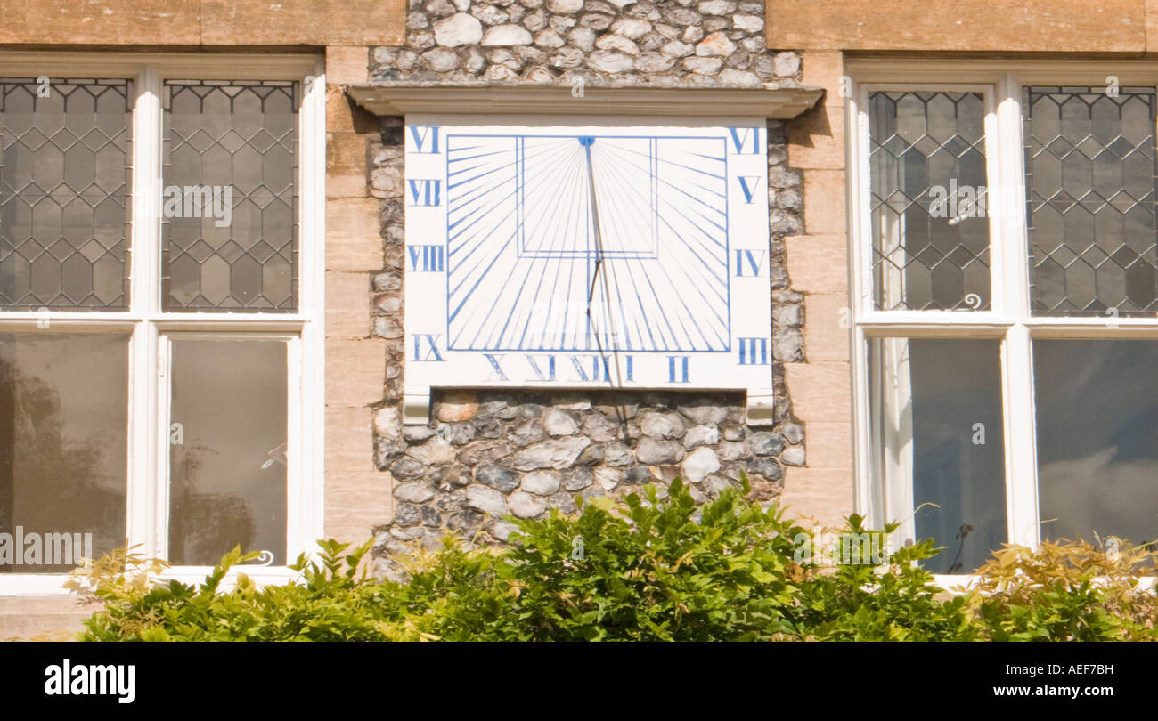 Sun dial on wall Stock Photo - Alamy