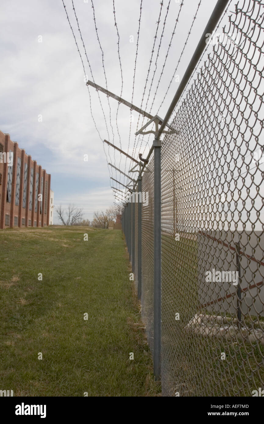 Perimeter fence around old prison building Stock Photo - Alamy