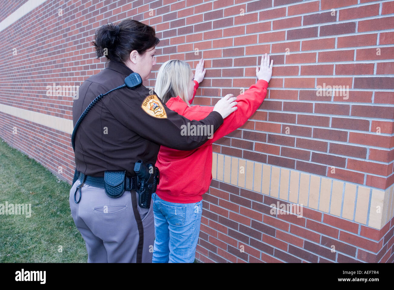 Young female being arrested by female deputy sheriff Saline County ...