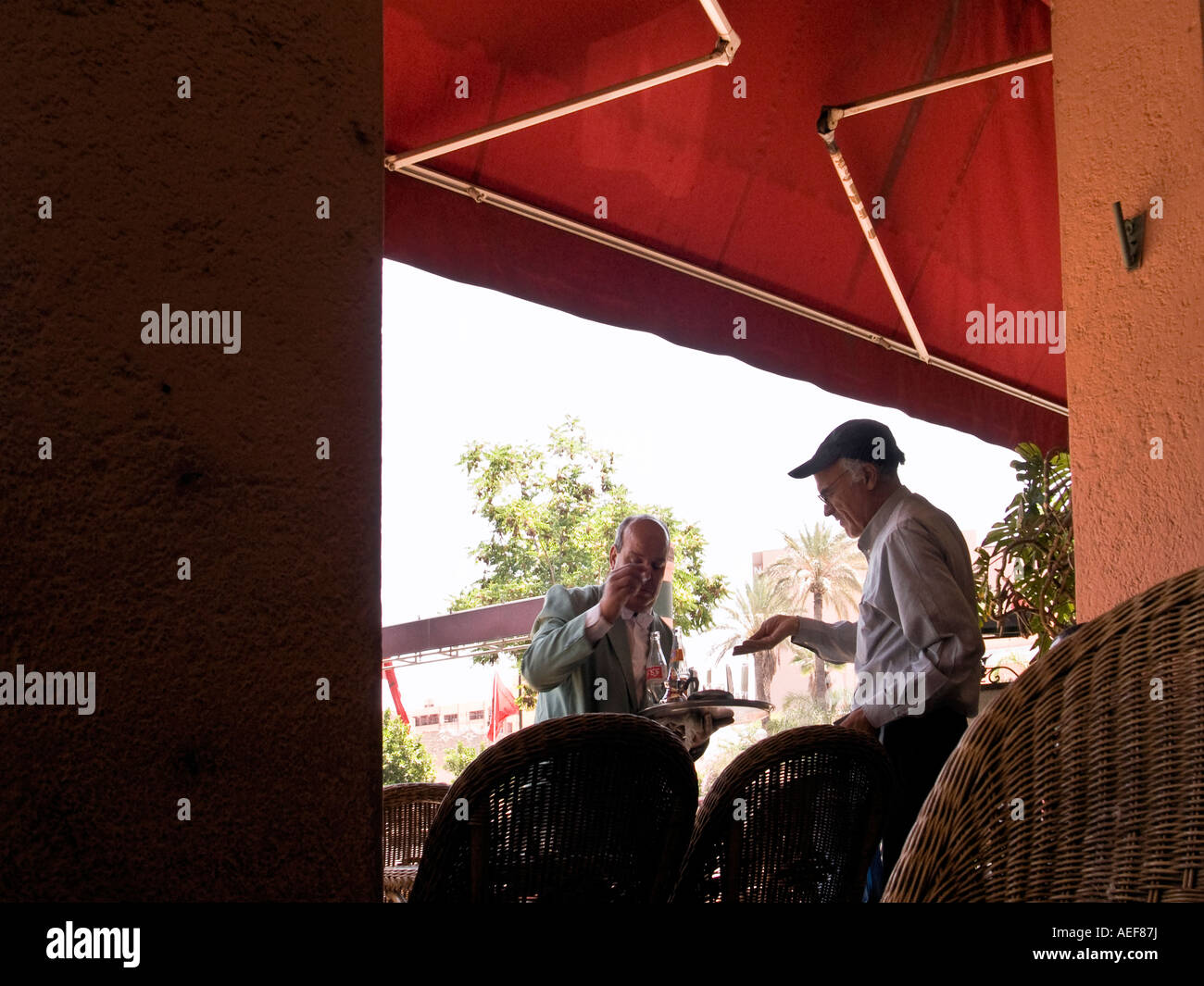 man tipping waiter in a cafe in Marrakech,Morocco Stock Photo - Alamy