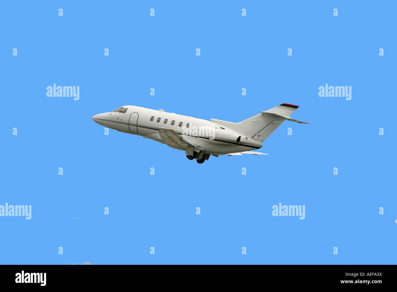 business jet taking off isolated over blue Stock Photo - Alamy