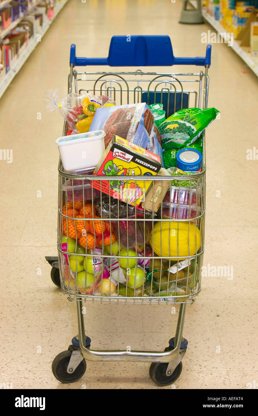 supermarket trolley full of food in a tesco store, Carlisle, Cumbria ...