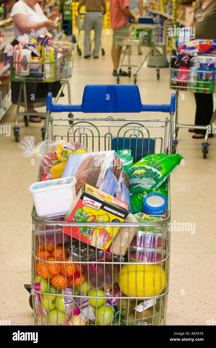 supermarket trolley full of food in a tesco store, Carlisle, Cumbria ...