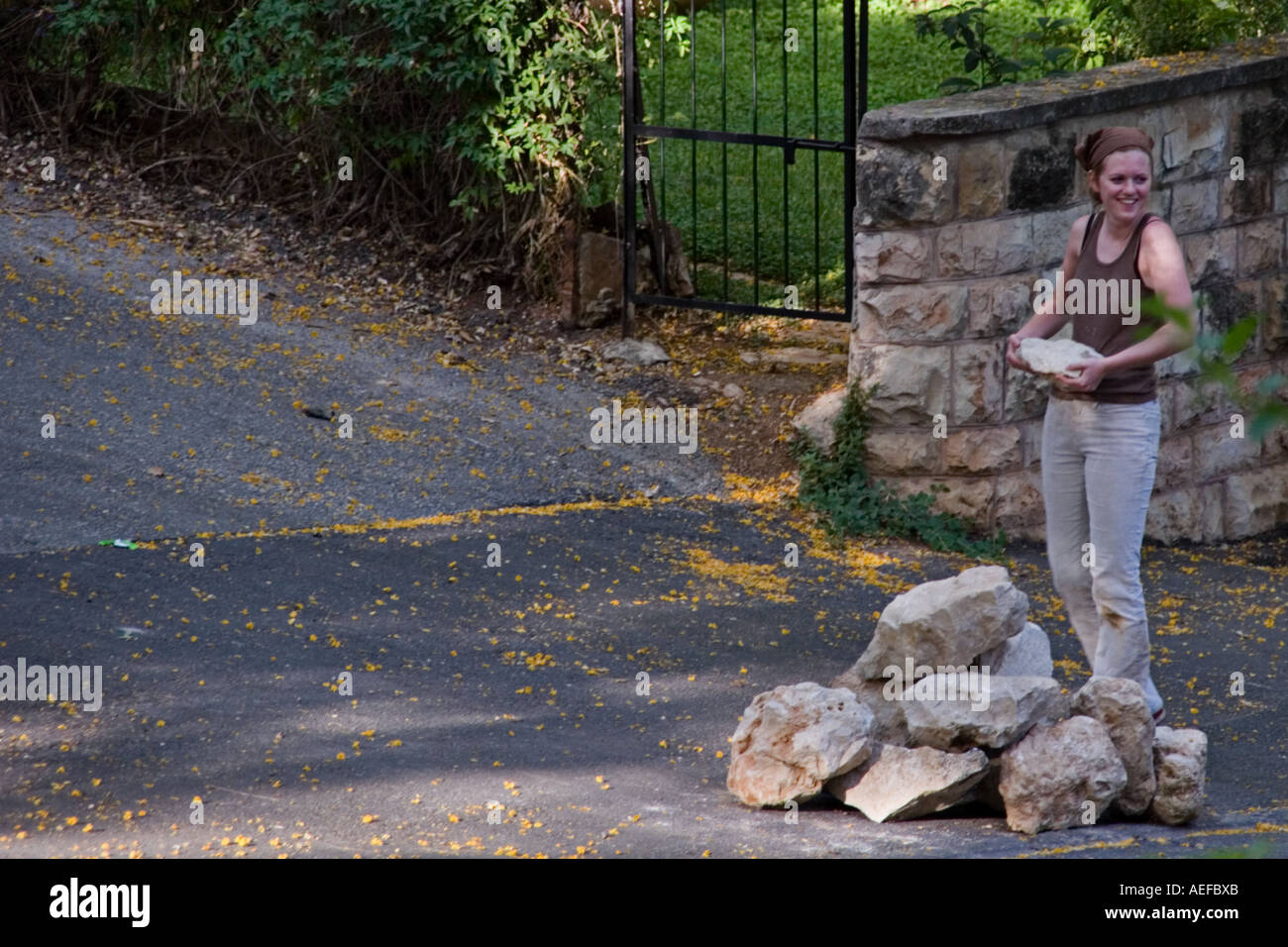 Stock photo of a woman lifting heavy rocks Stock Photo - Alamy