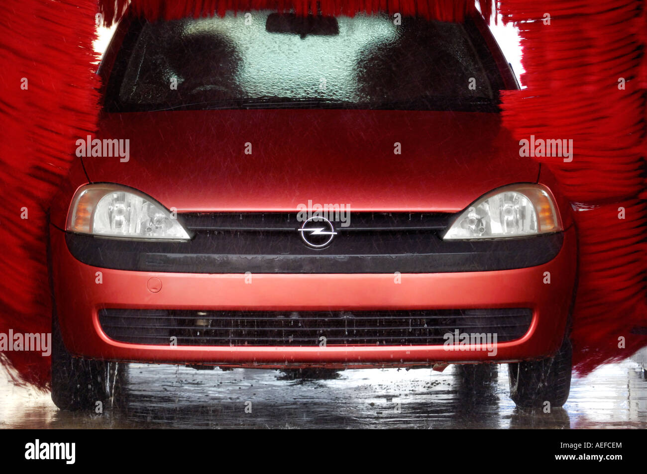 Red Opel Corsa automobile in a car wash auto service Stock Photo - Alamy