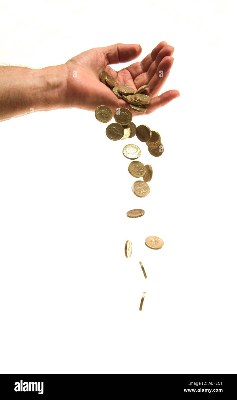 Pound coins falling from hand Stock Photo - Alamy