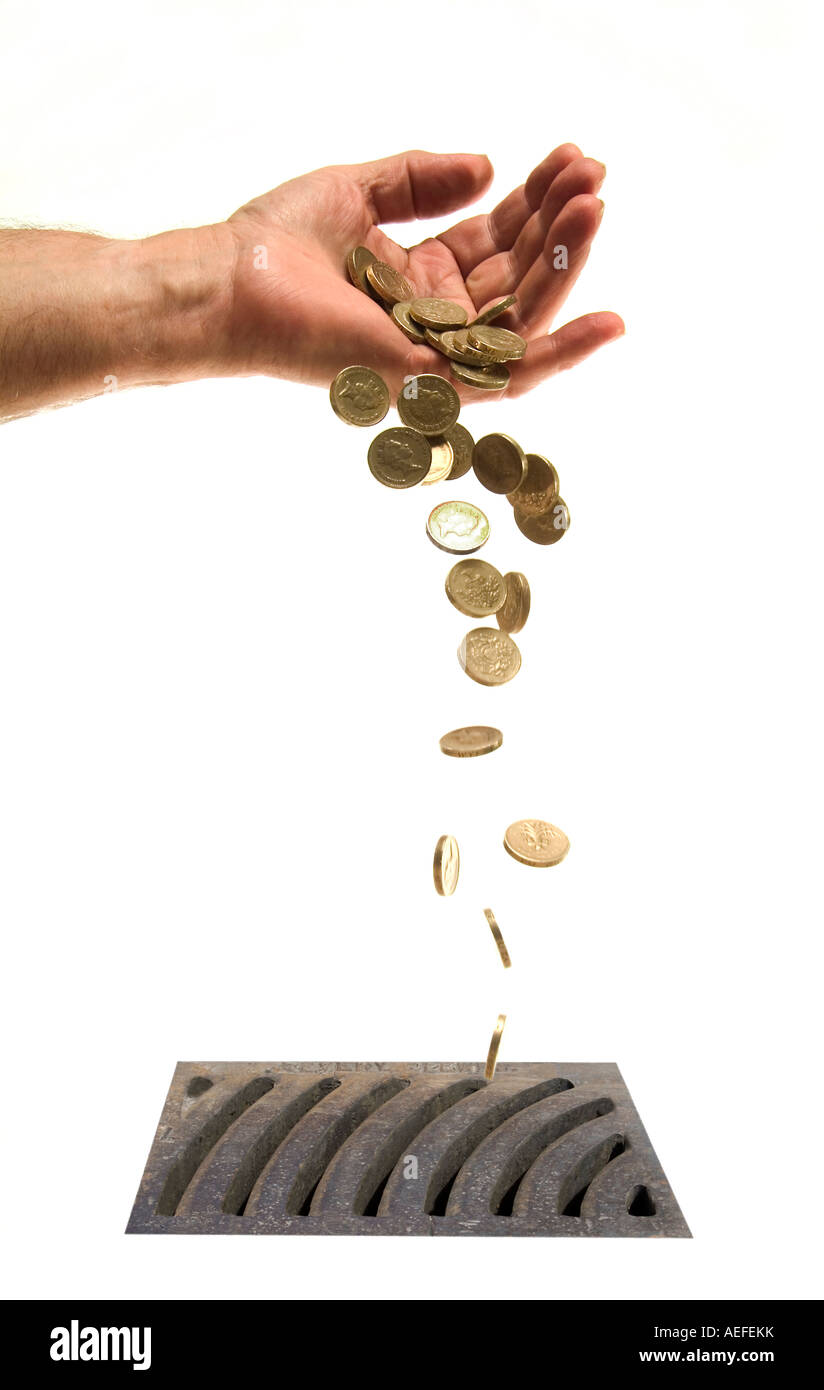Pound coins down the drain Stock Photo - Alamy
