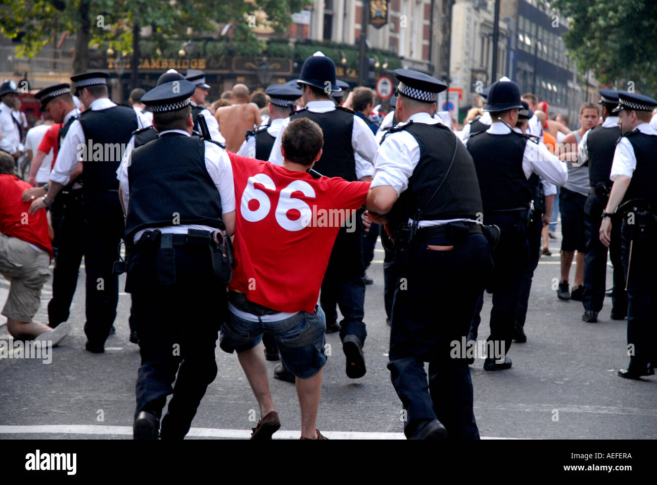 Police officers dragging and arresting young male football fan in ...