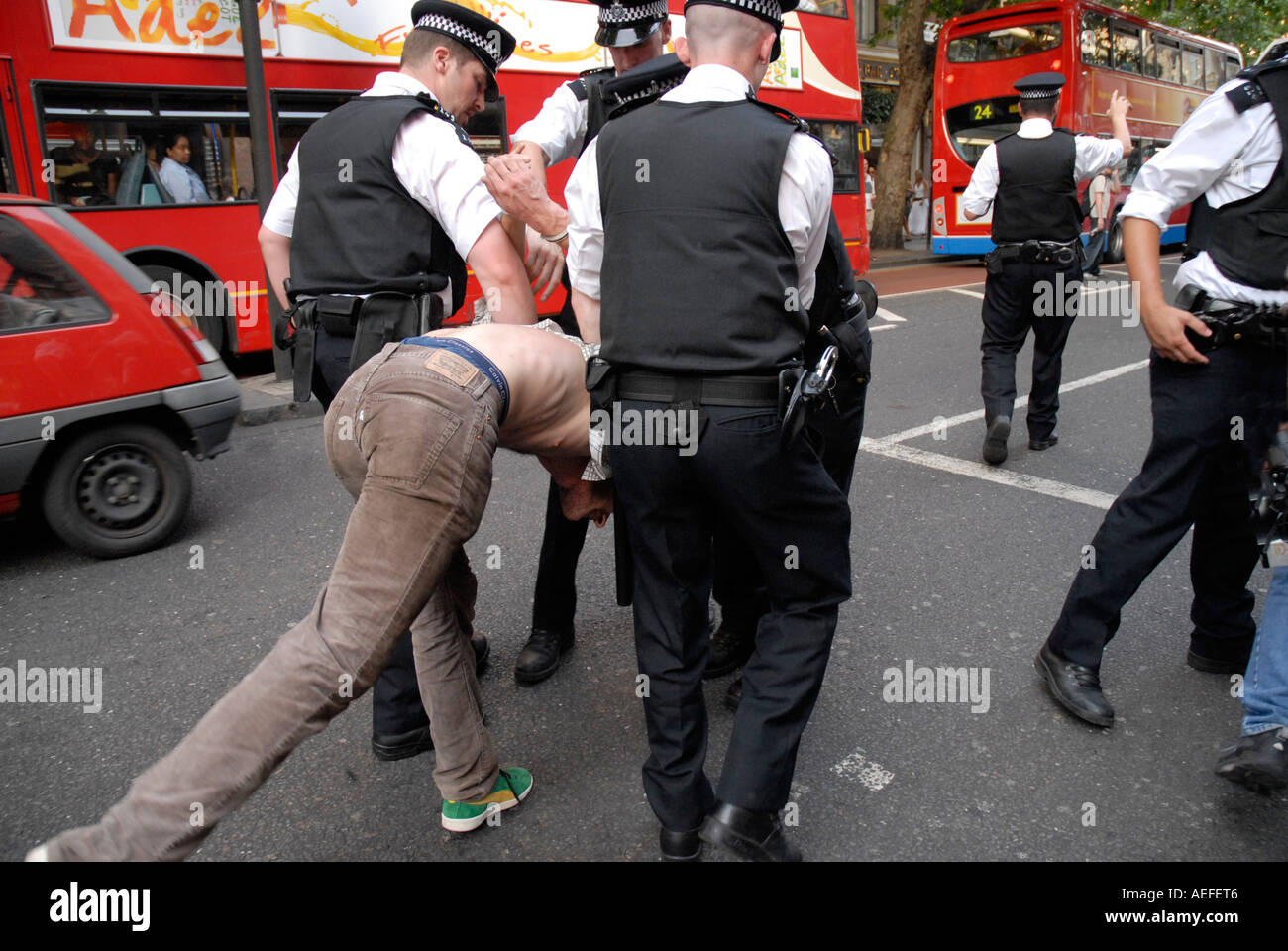 Police officers hold handcuff and arresting young football fan Central ...
