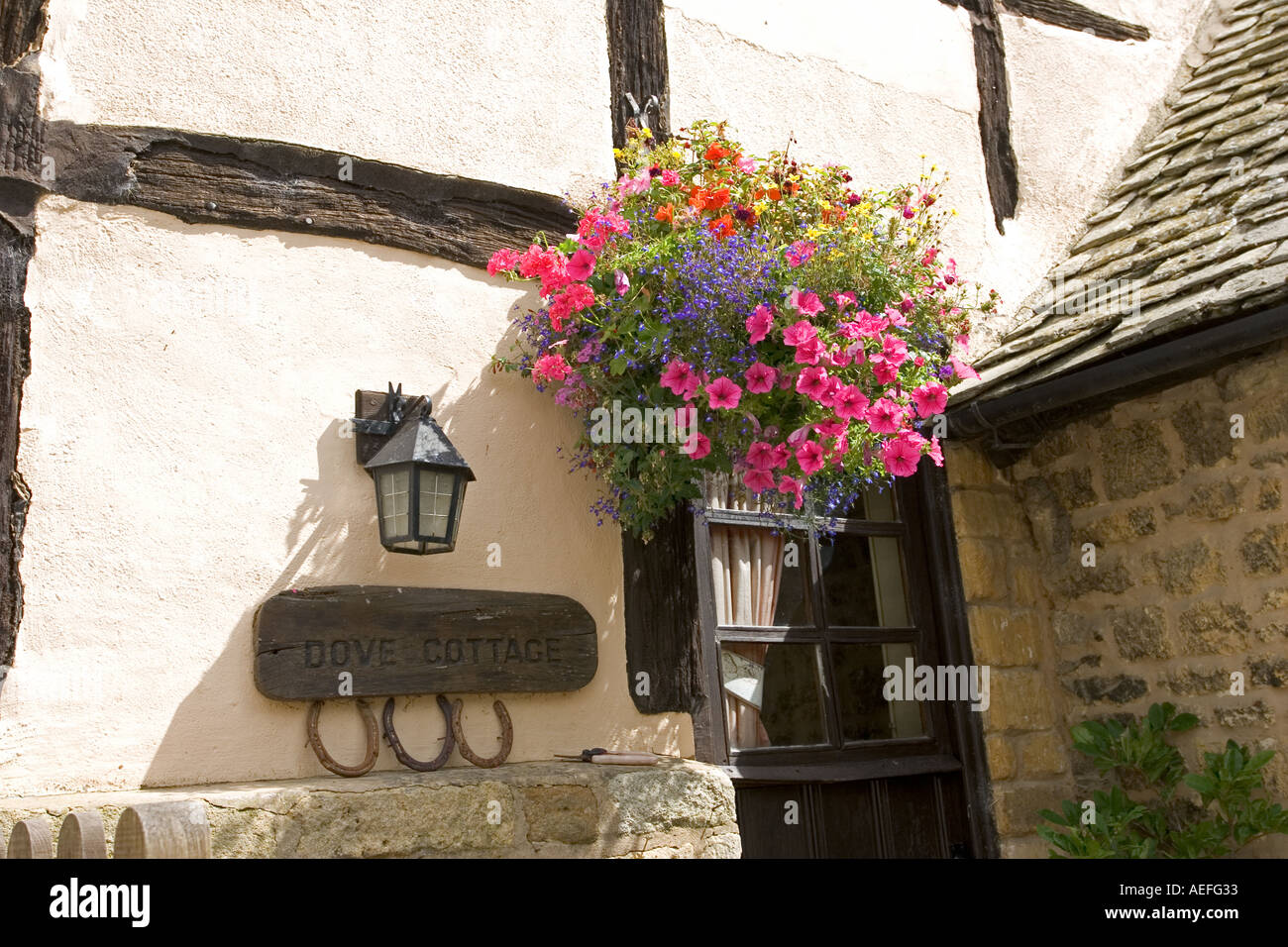 Hanging basket outside cottage hi-res stock photography and images - Alamy