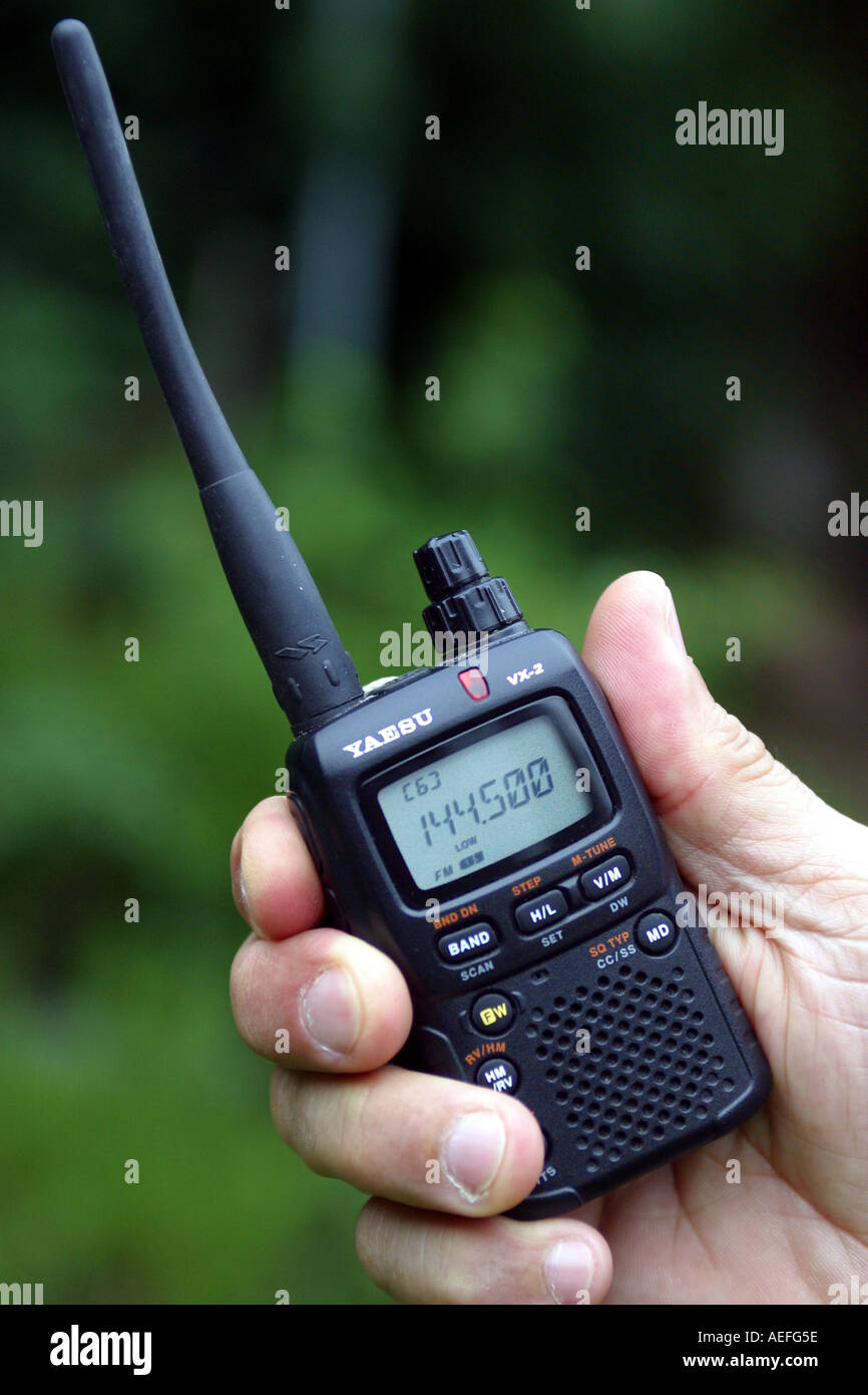 male hand holding a two way communications radio Stock Photo - Alamy
