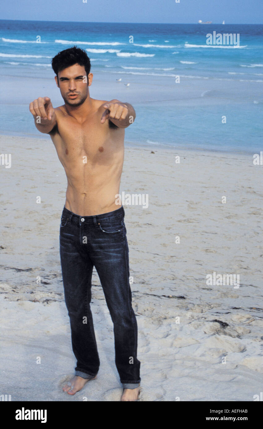 Man at the beach pointing Stock Photo - Alamy