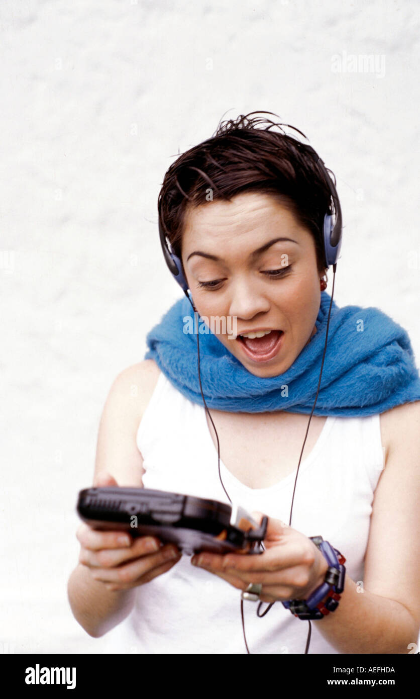 Young woman listening to CD walkman Stock Photo - Alamy
