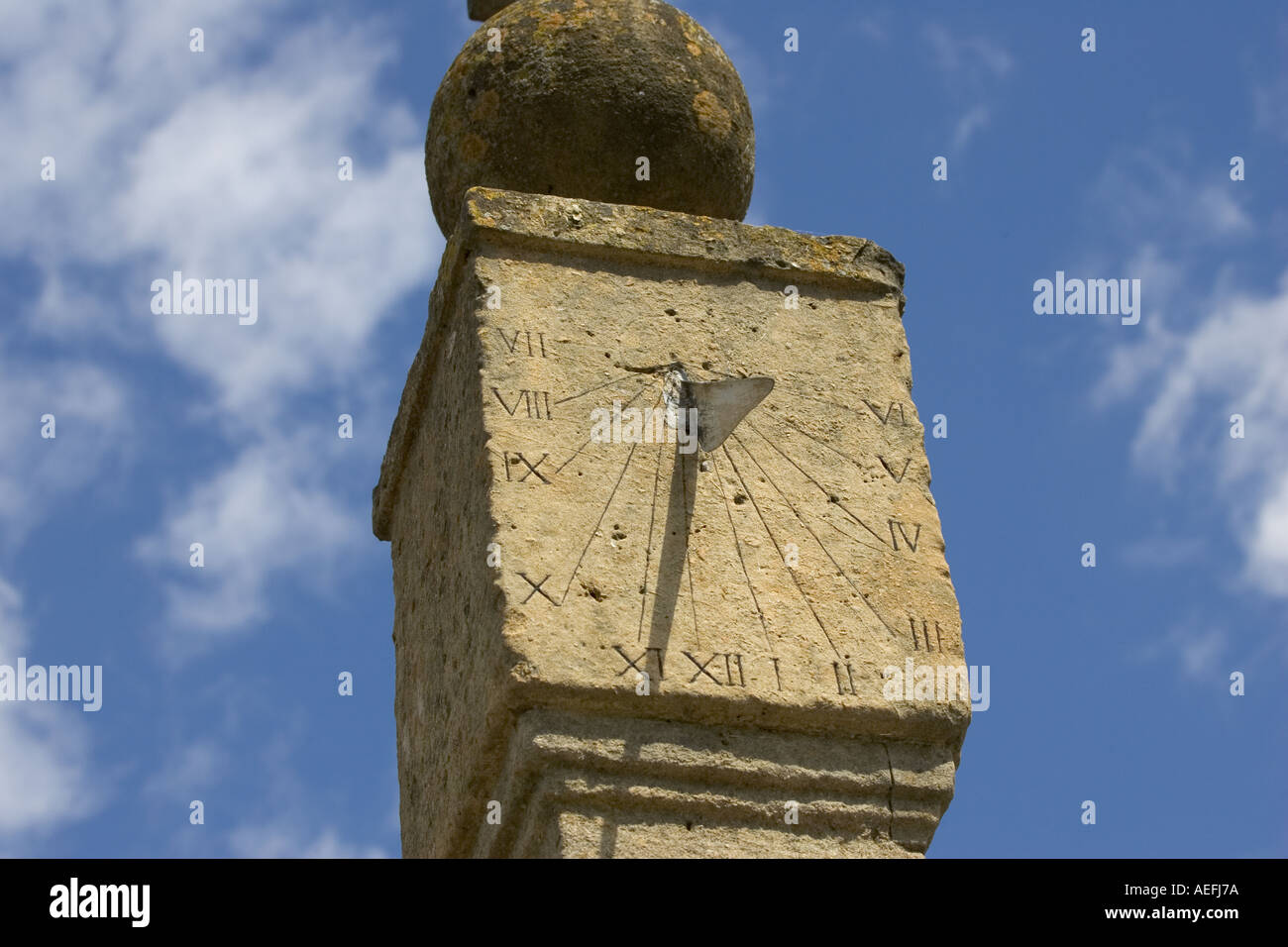 Sundial on medieval cross in Cotswold village of Stanton UK Stock Photo ...
