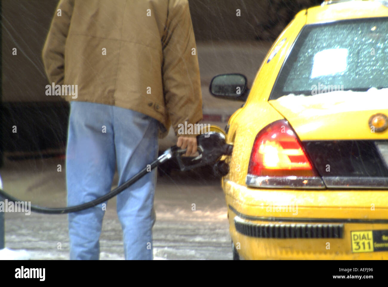 Taxi driver pumping gas Stock Photo - Alamy