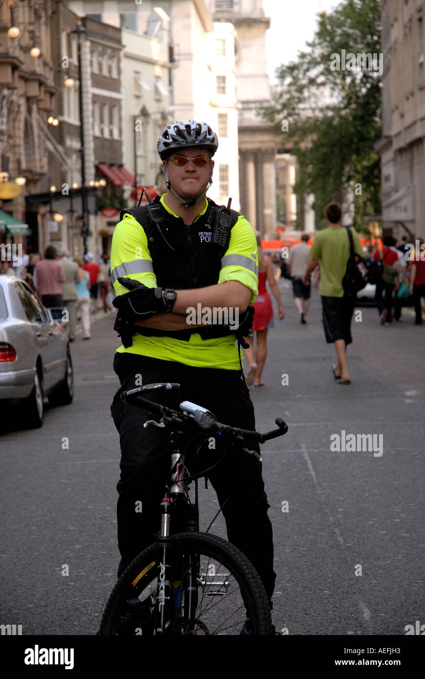Metropolitan Police officer patrolling on bicycle in central London ...