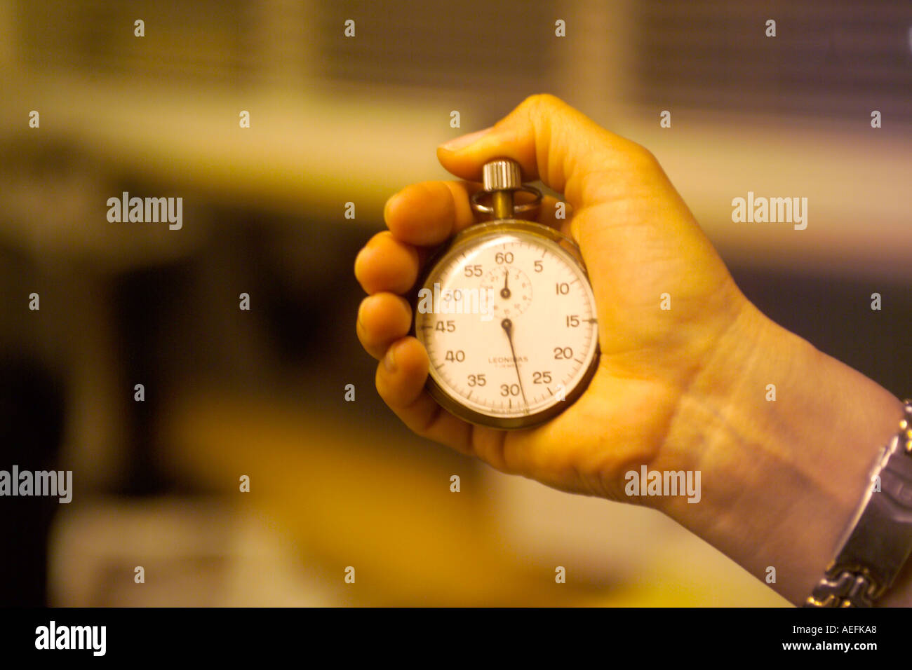 Hand holding stopwatch Stock Photo - Alamy
