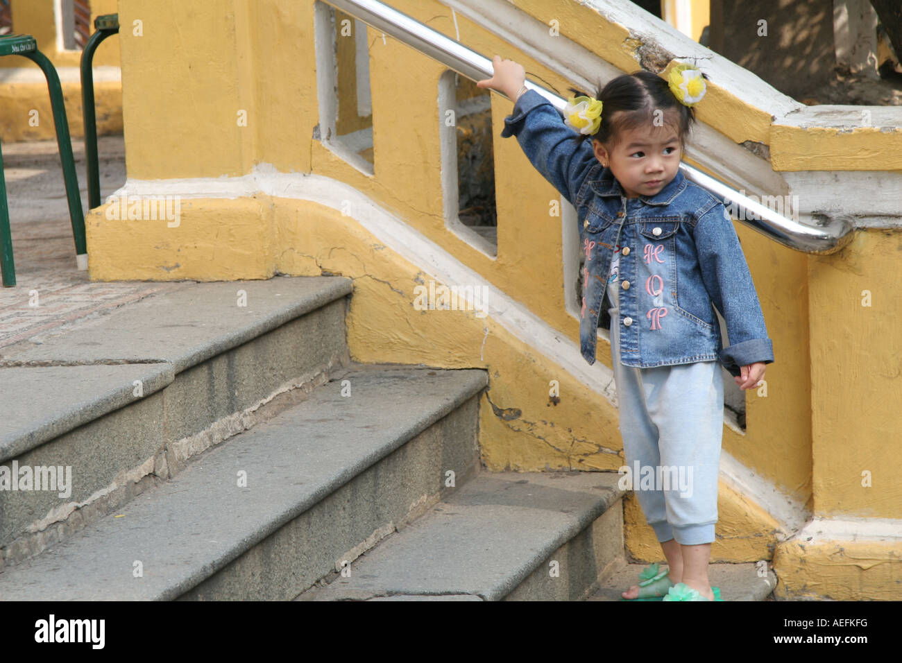 Small child at the temple steps Stock Photo - Alamy