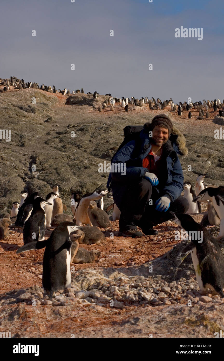 photographer Steven Kazlowski at a chinstrap penguin Pygoscelis antarctica rookery on the South ...