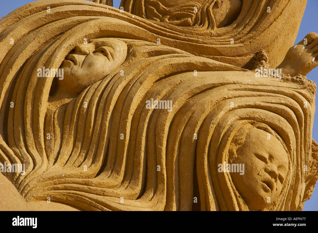 sand sculpture with pain-distorted faces Stock Photo - Alamy