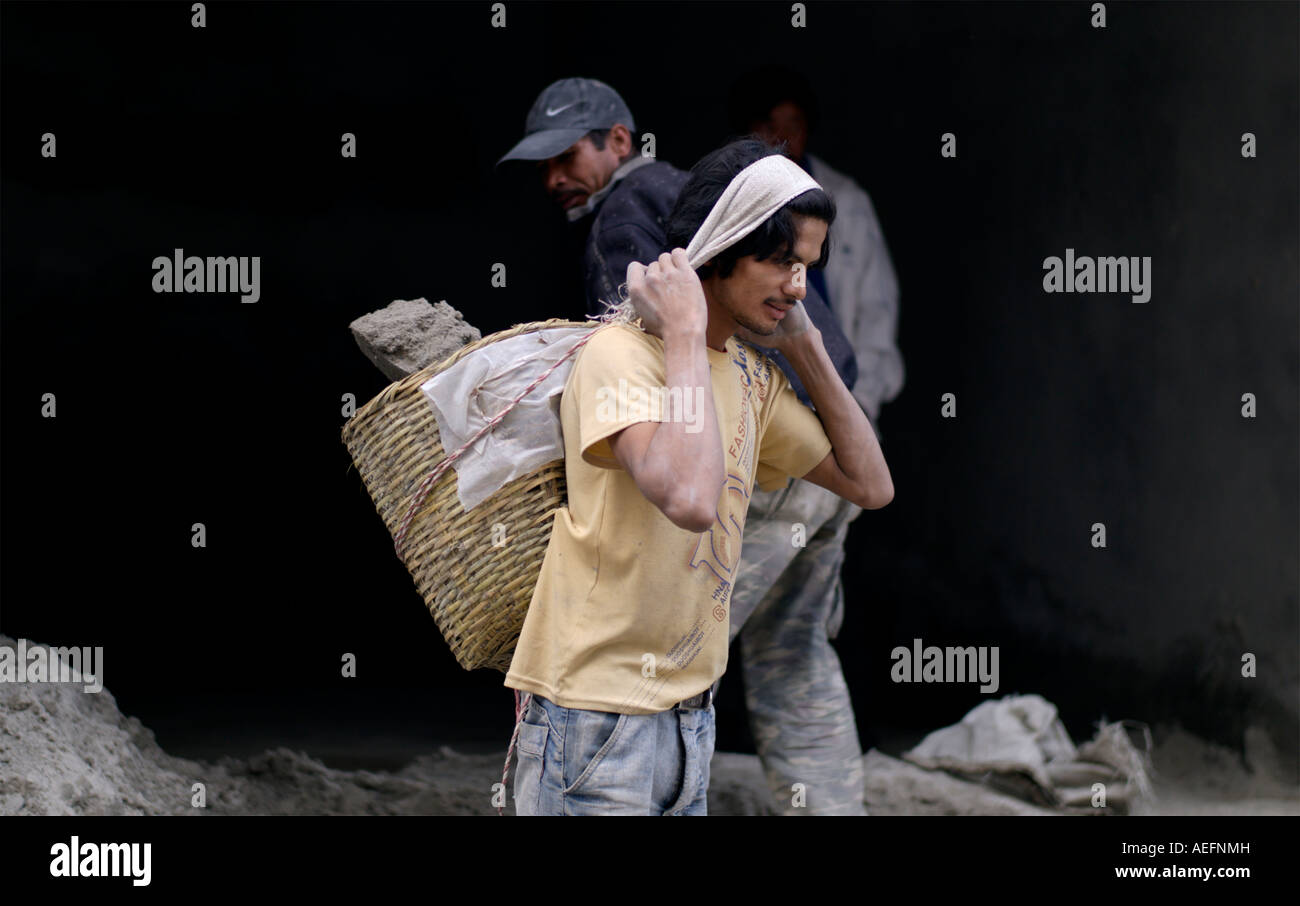 Man carrying load of cement on his head Stock Photo - Alamy