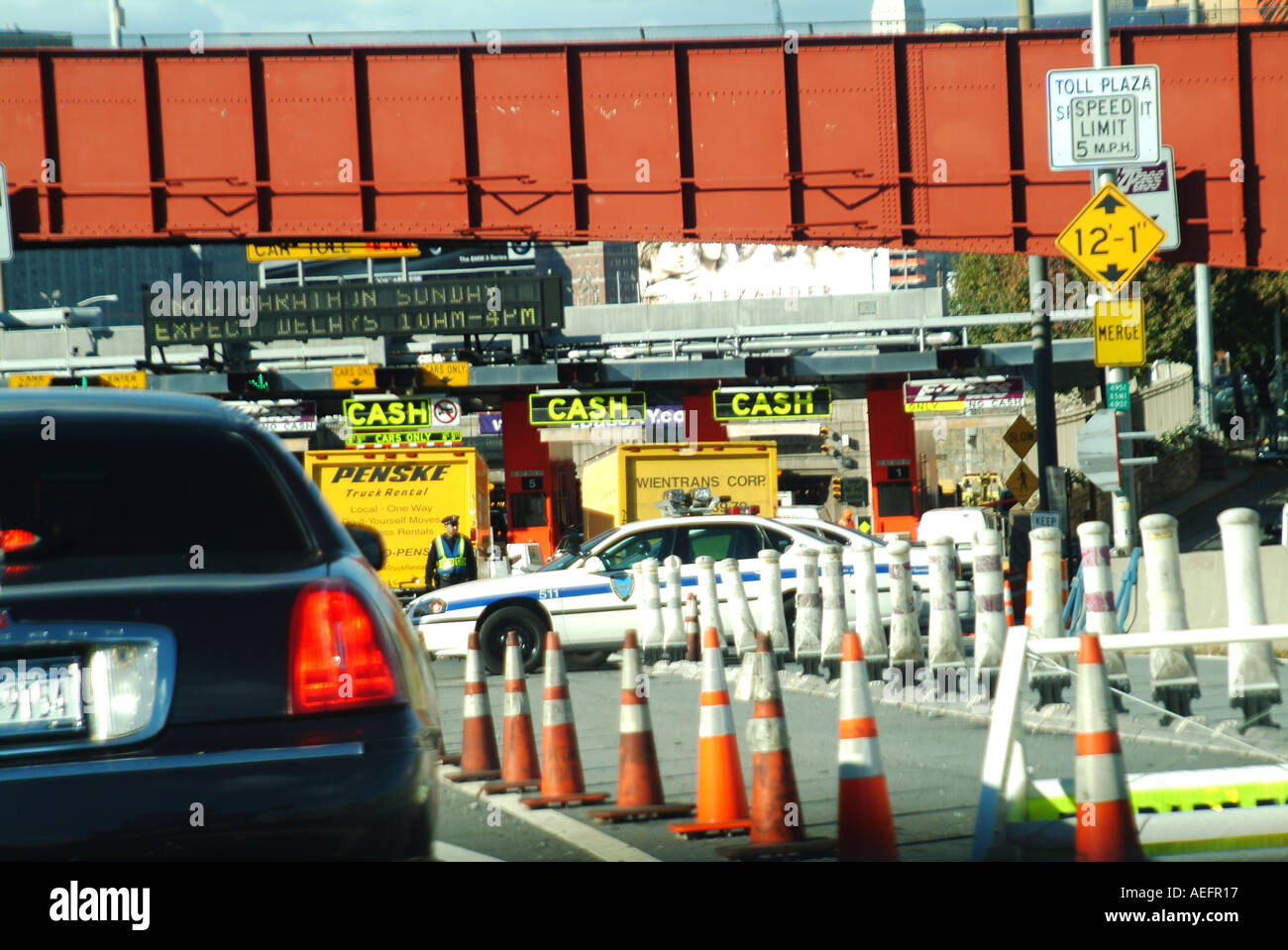 Cars approaching toll booth Stock Photo - Alamy