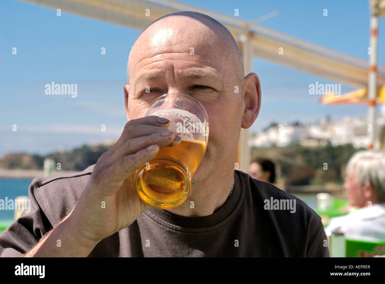 A bald man drinking a pint of beer Stock Photo - Alamy