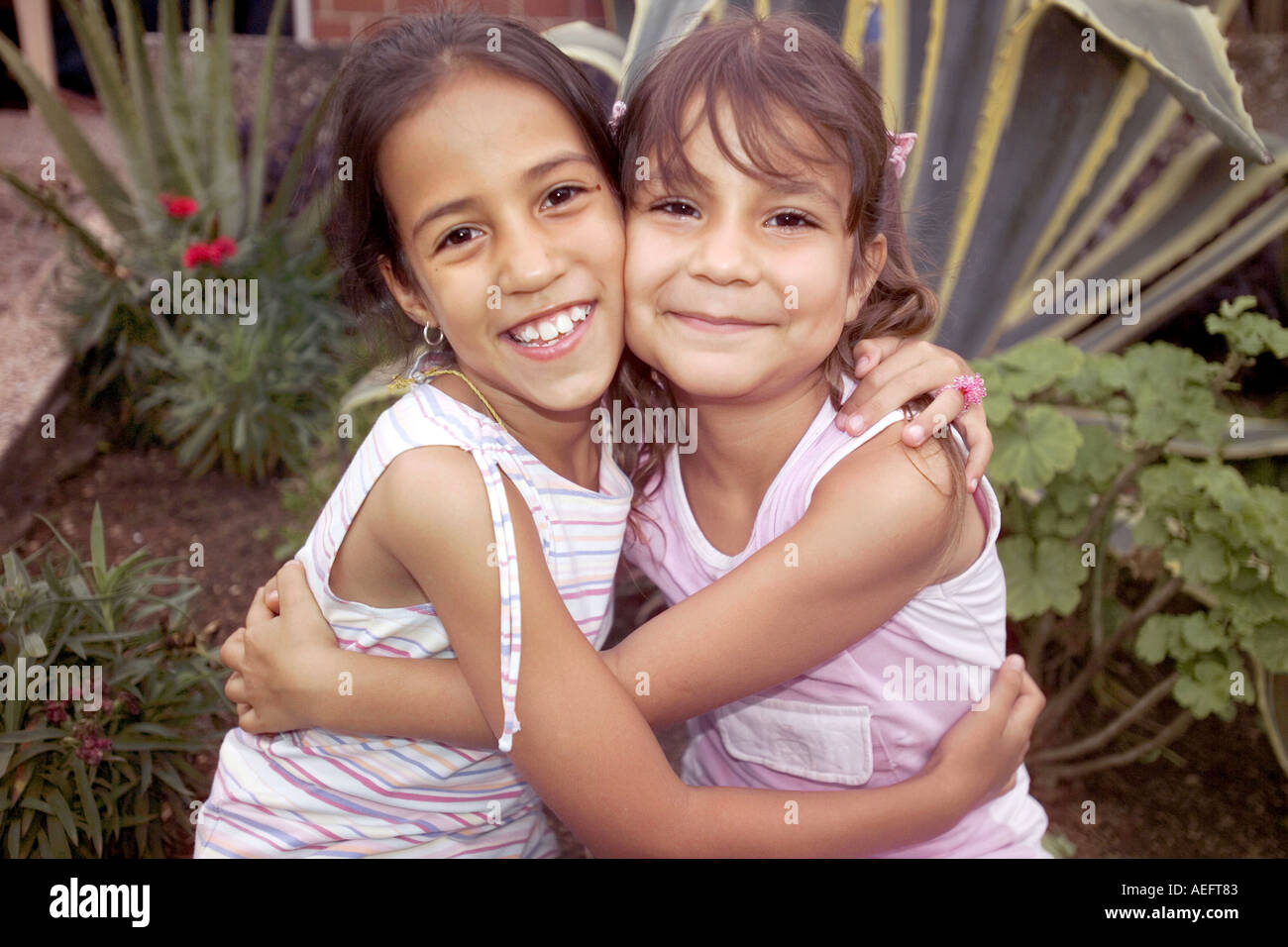 Young girls hugging Stock Photo - Alamy